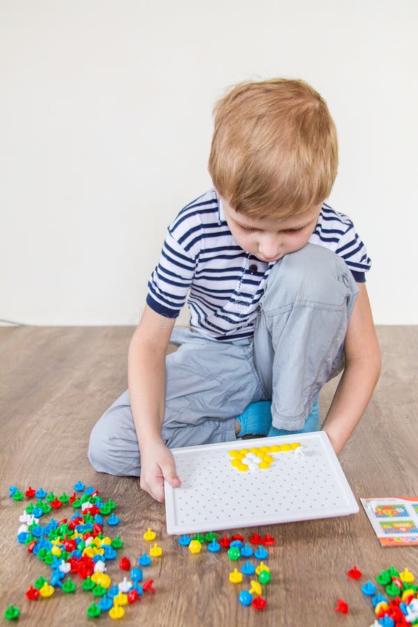 Boy playing in a mosaic stock image. Image of toys, floor - 87497257