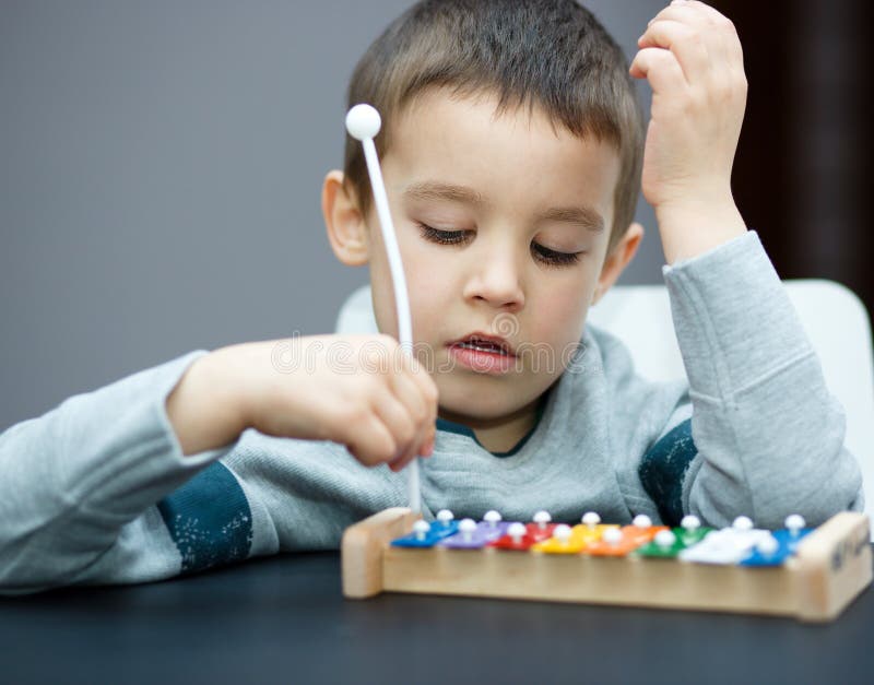 Boy is Playing a Musical Instrument Stock Photo - Image of blocks ...