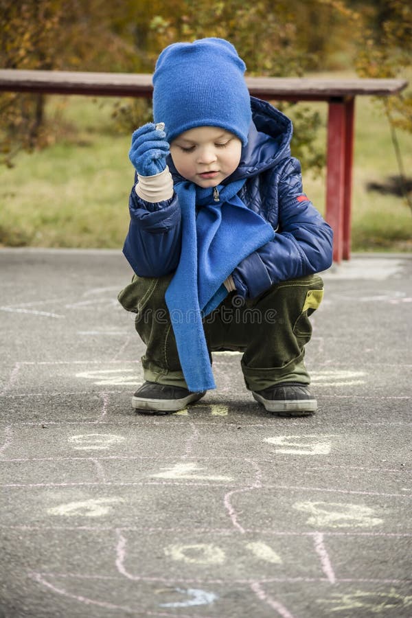 Boy playing outside stock photo. Image of road, jacket - 61908960