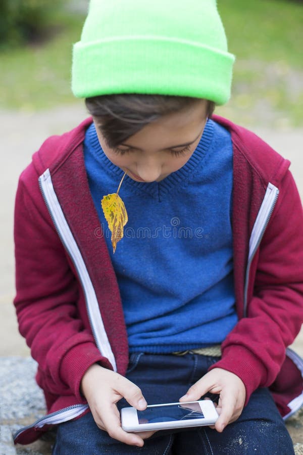 Boy playing on phone stock image. Image of portrait, autumn - 45652977