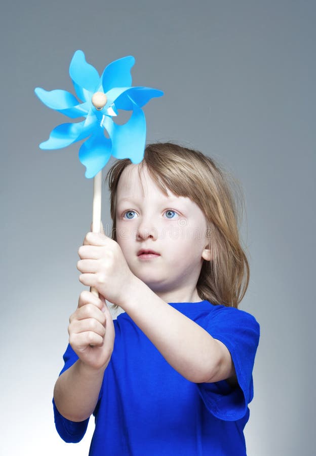 Boy playing with pinwheel stock photo. Image of blue - 24485660