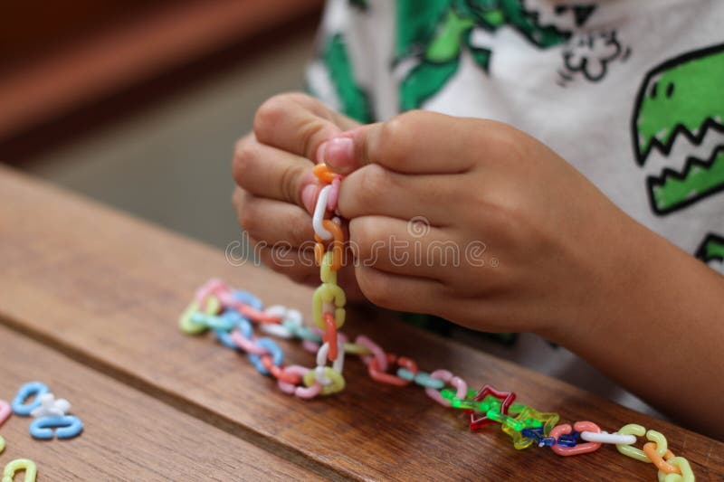 A Boy is Playing Plastic Chain Toy Stock Photo - Image of detail ...