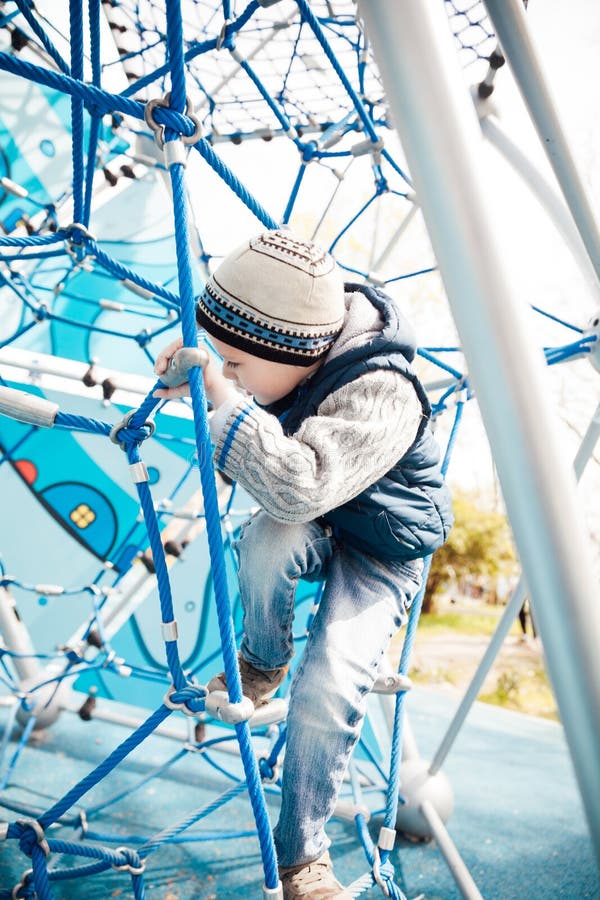 Little Boy Playing on the Playground in the Park Stock Photo - Image of ...