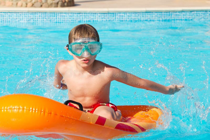 Boy Playing on Dingy in Pool Stock Photo - Image of active, lovable ...