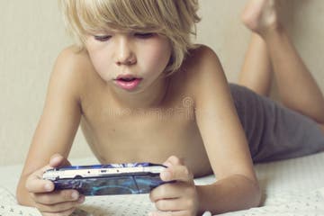 Boy playing on the PSP stock image. Image of happy, hobbies - 33005357