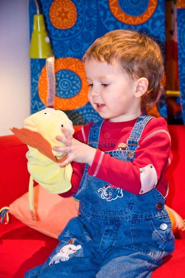Boy playing with a puppet stock image. Image of fashionable - 7487027