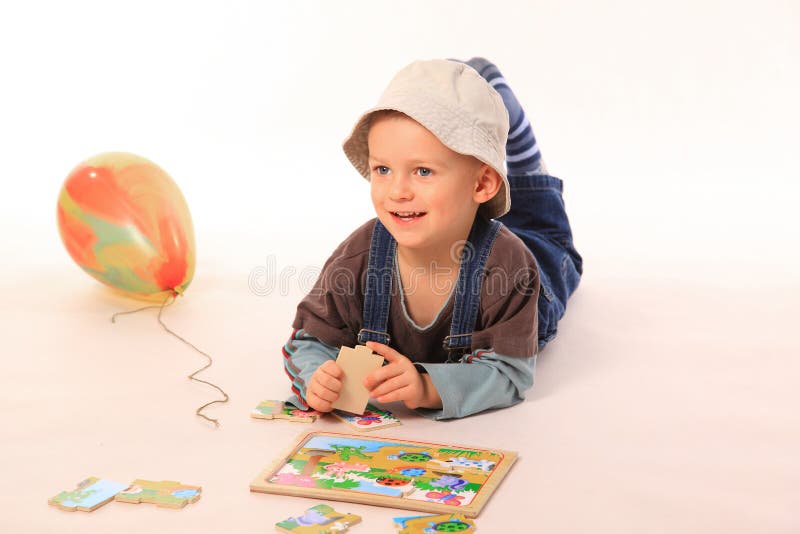 Boy playing with puzzle stock photo. Image of childhood - 13141558