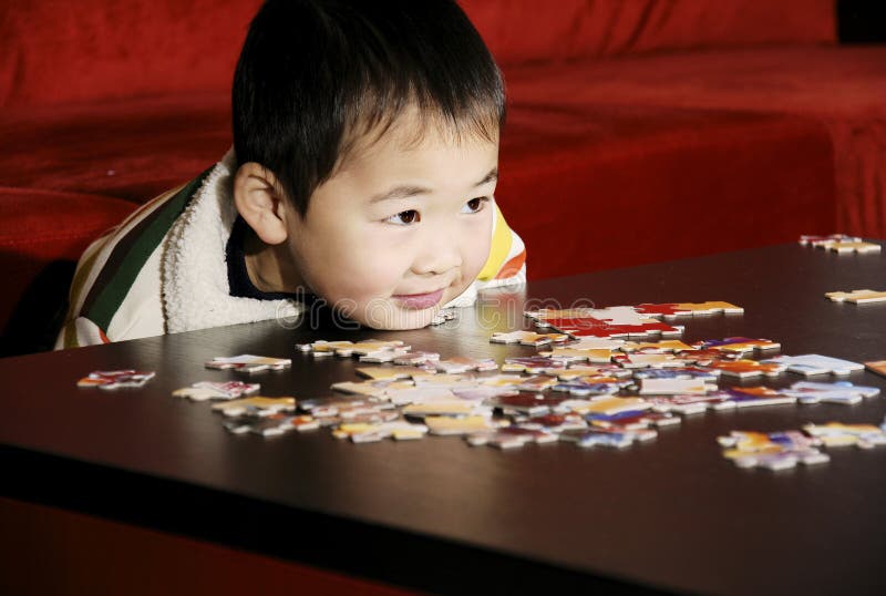 Boy playing puzzle game stock photo. Image of face, play - 7710060