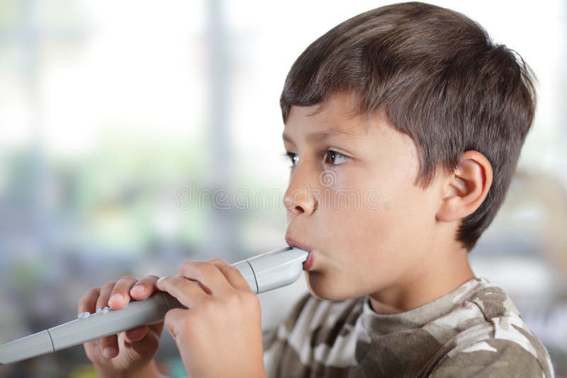 Boy playing recorder stock photo. Image of joyful, blowing - 26123936