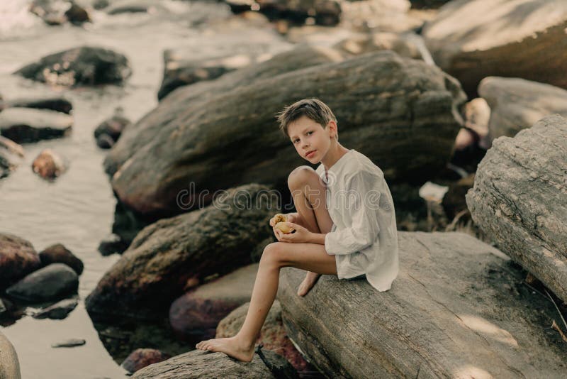 The Boy is Playing on Rocks Stock Photo - Image of ocean, lifestyle ...