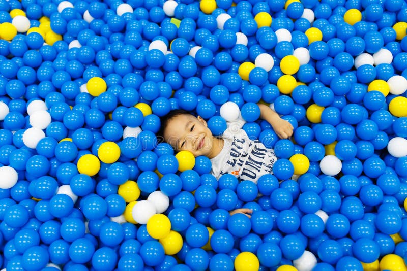 A Boy in Playing Room with Many Balls Stock Photo - Image of activity ...