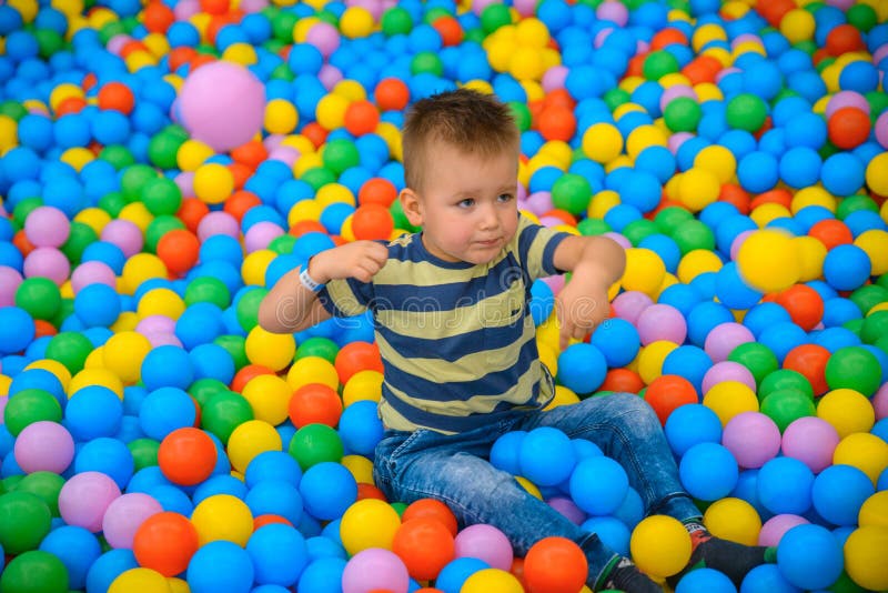 A Boy in the Playing Room with Many Little Colored Balls Stock Image ...