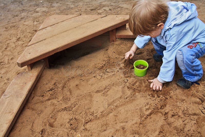 Boy playing with sand stock photo. Image of lonely, playful - 21156890