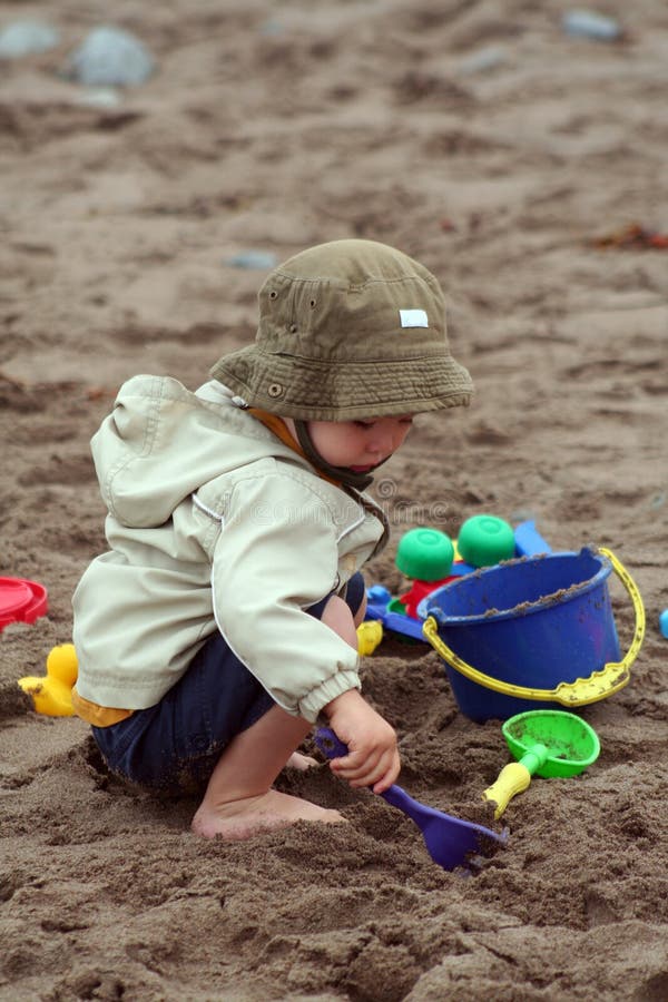 Boy Playing in Sand stock image. Image of young, portrait - 6139797