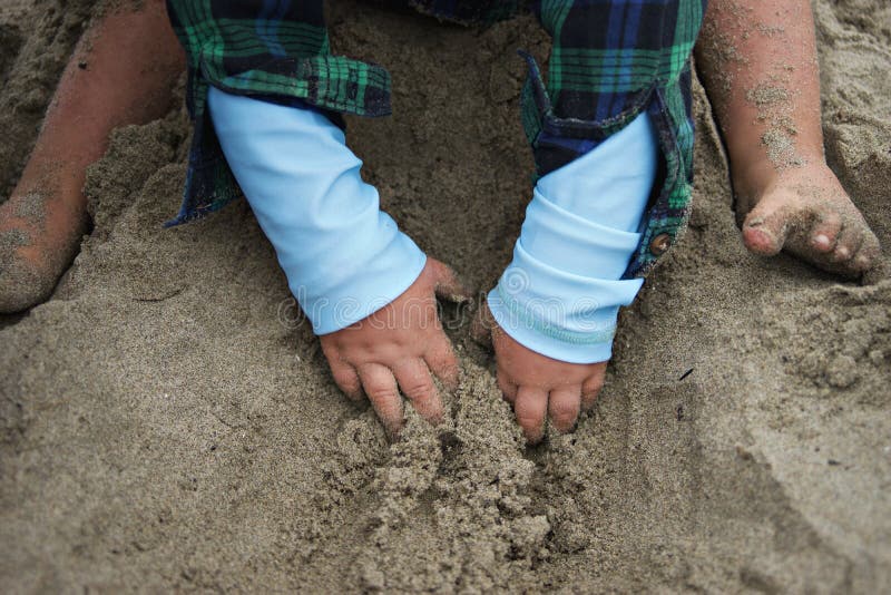 Boy playing in the sand stock photo. Image of calm, blue - 197623788