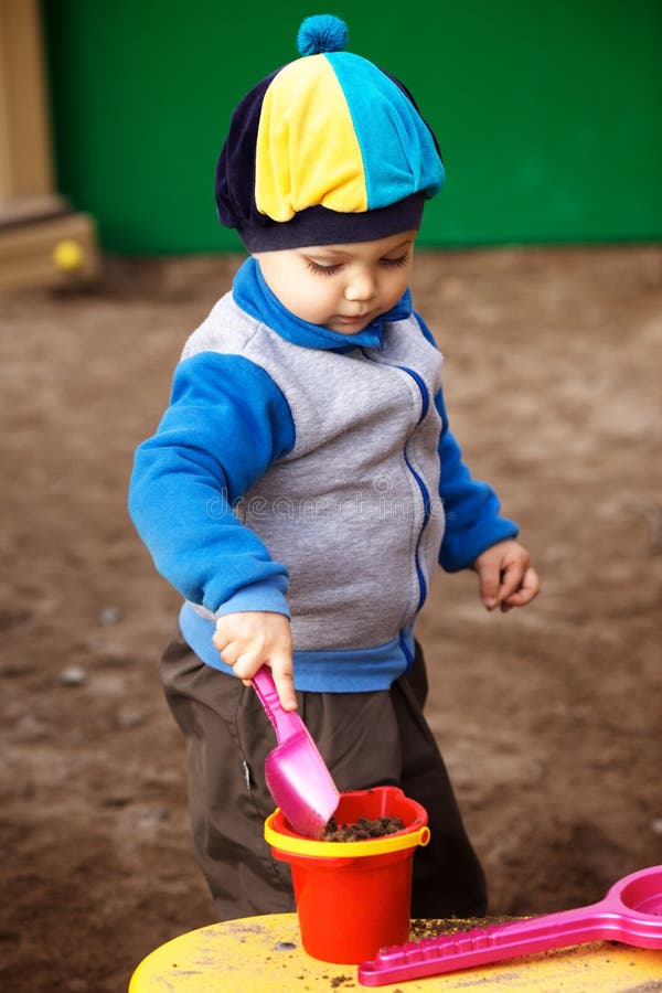 Boy Playing in Sandbox stock photo. Image of playful - 28874260