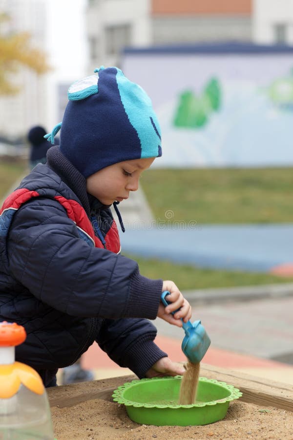 Boy playing in sandbox stock photo. Image of activity - 48000726