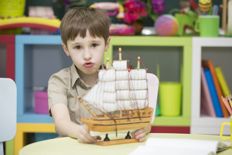 Boy playing with ship. stock image. Image of childhood - 177143421
