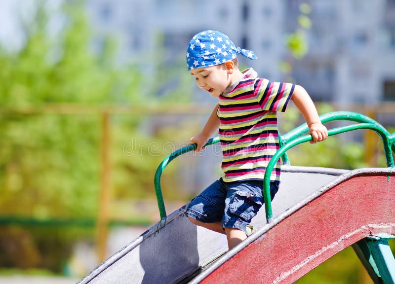 Boy playing on slide stock photo. Image of urban, enjoyment - 24668592