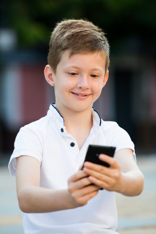 Boy Playing with Smartphone Stock Image - Image of expression, outdoors ...