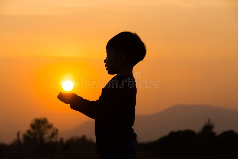 A Boy Playing with the Sun at Sun Set. Stock Image - Image of ...