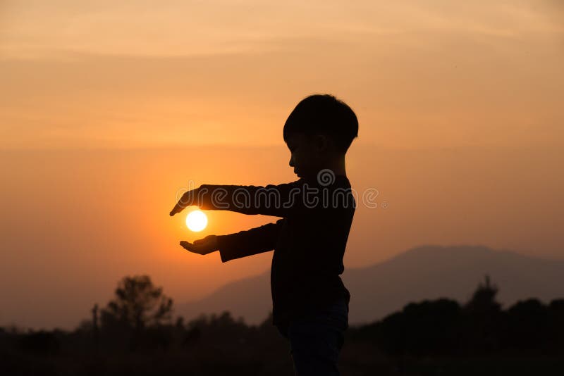 A Boy Playing with the Sun at Sun Set. Stock Image - Image of kids ...
