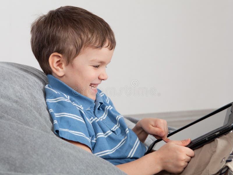 Boy playing on tablet stock photo. Image of touchscreen - 29189216