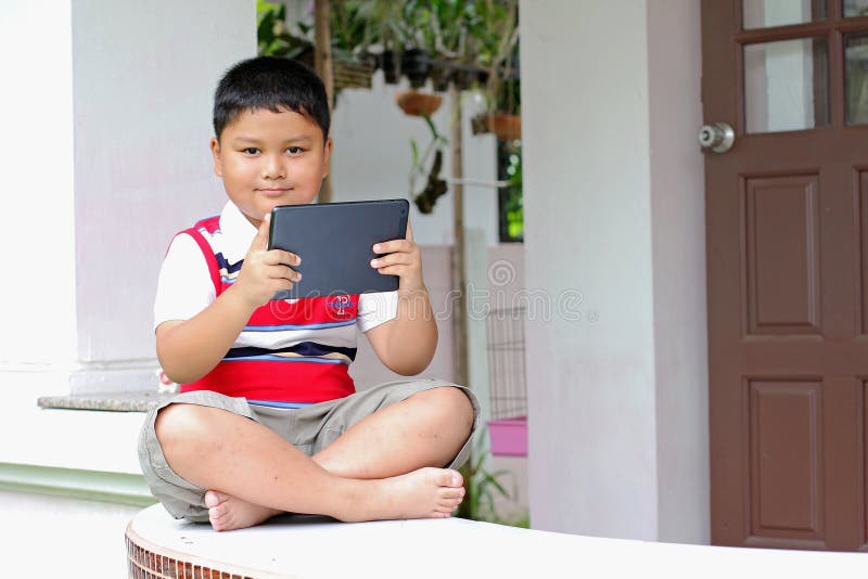 Little Boy playing Tablet stock image. Image of computer - 32478499