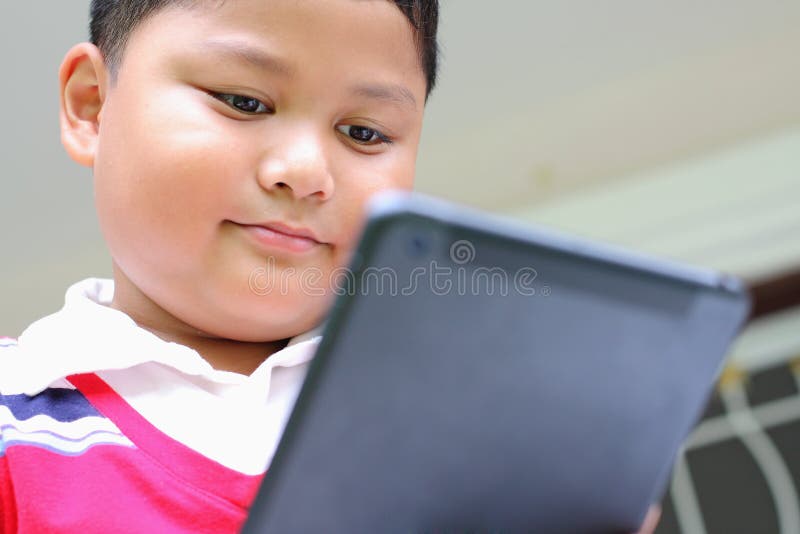 Boy playing Tablet stock image. Image of child, game - 32478507