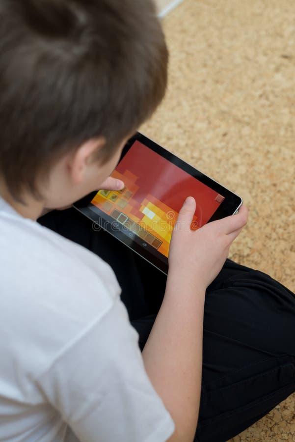 Boy playing on Tablet PC stock image. Image of plays - 39801129