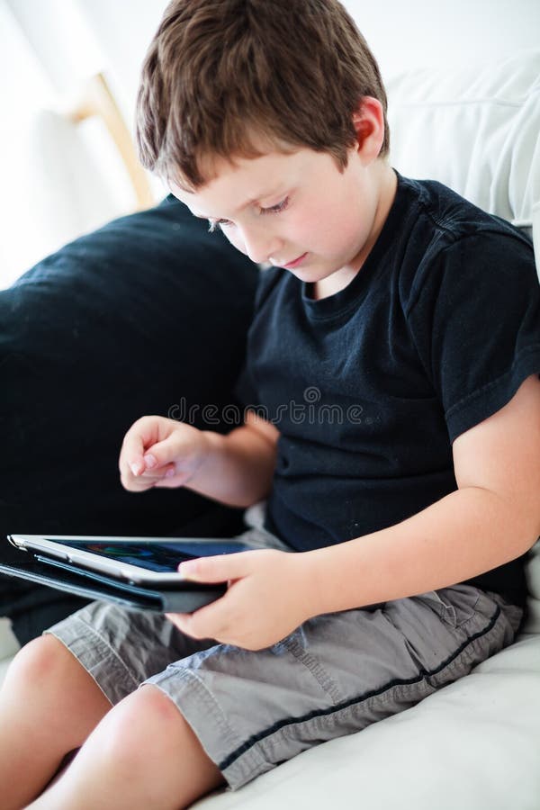 Boy reading on a tablet stock image. Image of outside - 30509249