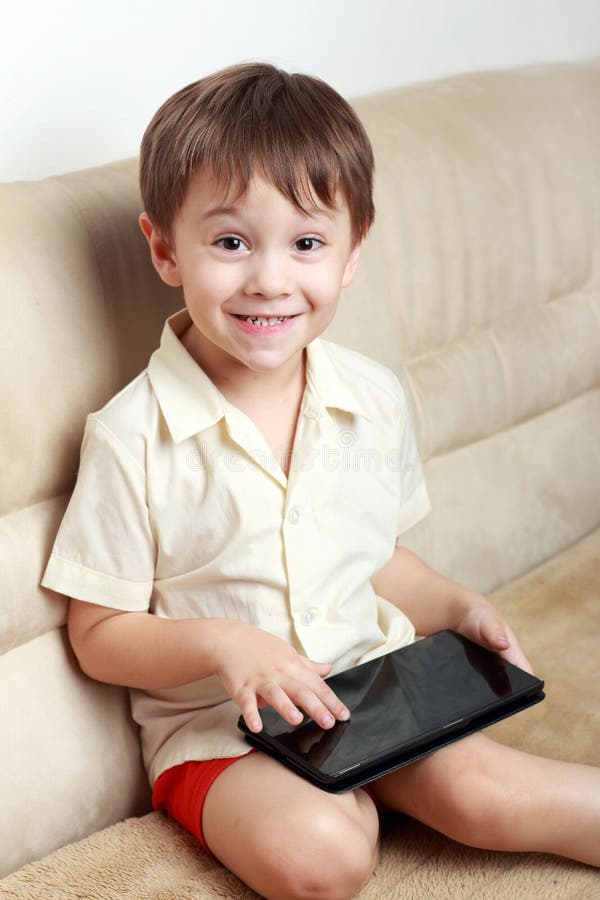 Boy playing on the tablet stock image. Image of holding - 49603537