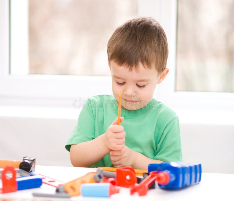 Boy is playing with tools stock photo. Image of funny - 36846684