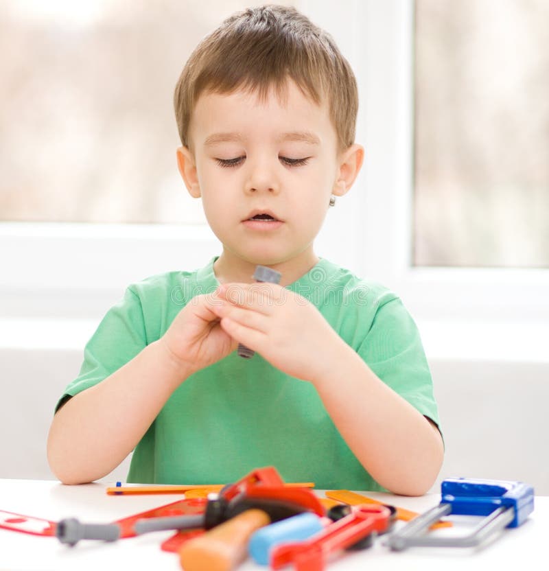 Boy is playing with tools stock photo. Image of smile - 36871498