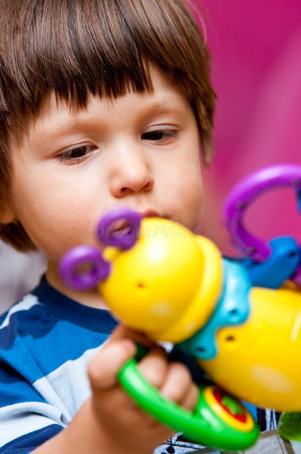 Boy playing with toy stock image. Image of happy, portrait - 20756805