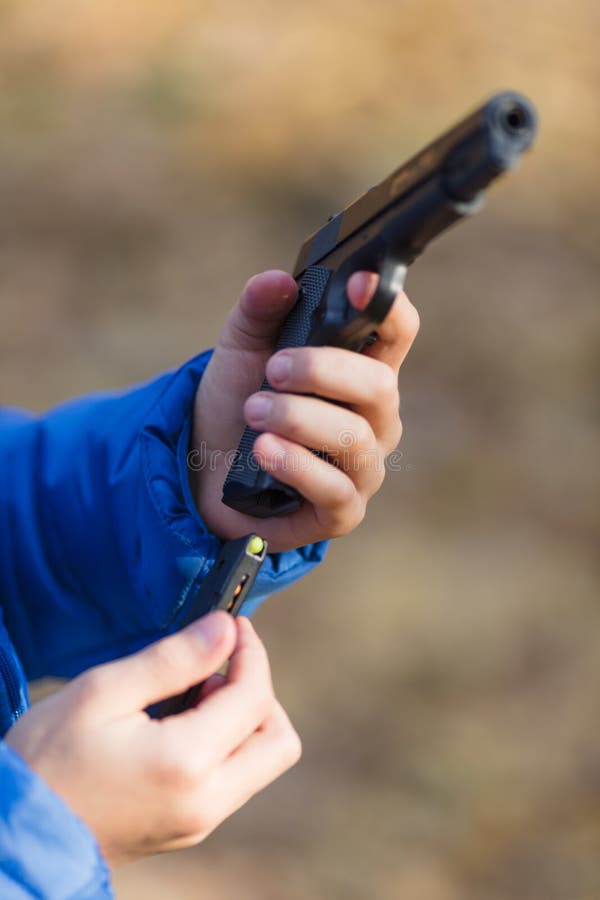 Boy Playing with a Toy Gun on the Street in Autumn Stock Photo - Image ...