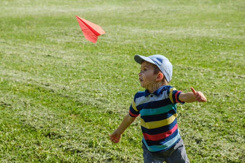 Boy Playing with a Toy Red Plane at Park on a Sunny Day Stock Photo ...
