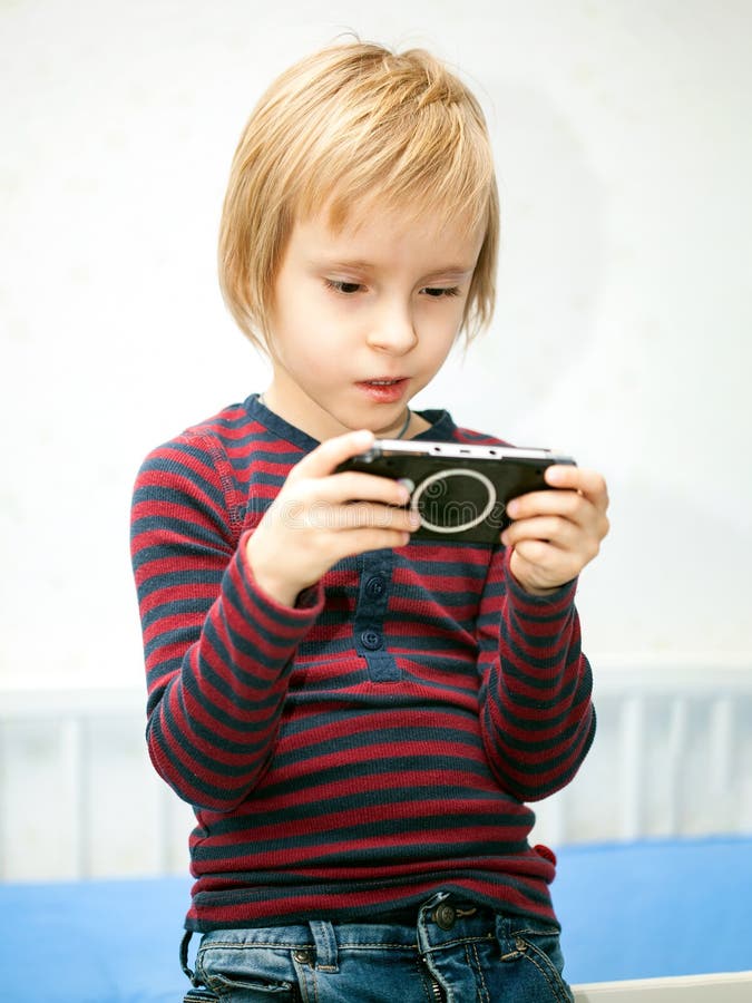 A Boy Playing a Video Game on His Game Console Stock Image - Image of ...