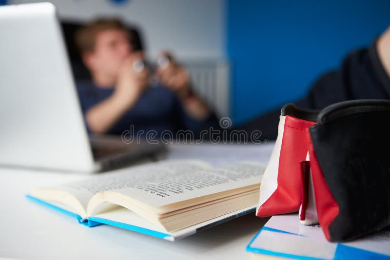 Boy Playing Video Game instead of Studying Stock Photo - Image of ...