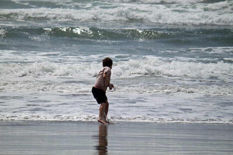 Playing in the waves stock image. Image of beach, sand - 103035301
