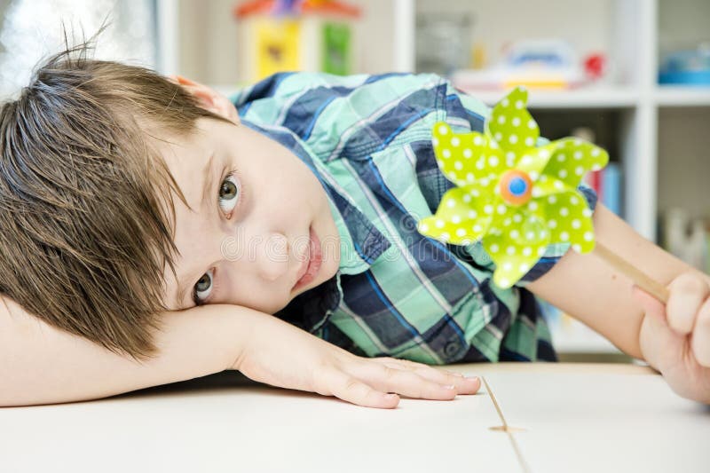 Boy Playing with Windmill at Home Stock Image - Image of holds, lies ...