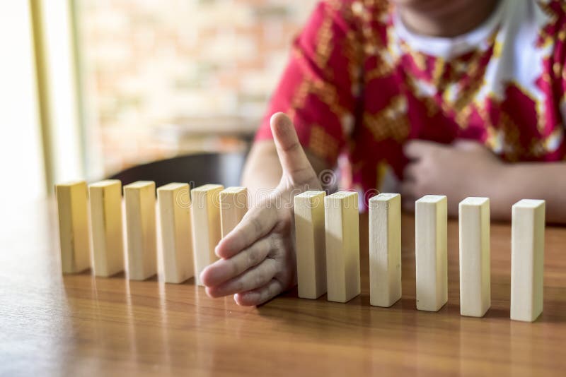 Boy is Playing Wood Blocks Stack Game by His Hand. Business Concept ...