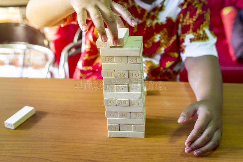 Boy is Playing Wood Blocks Stack Game by His Hand. Business Concept ...