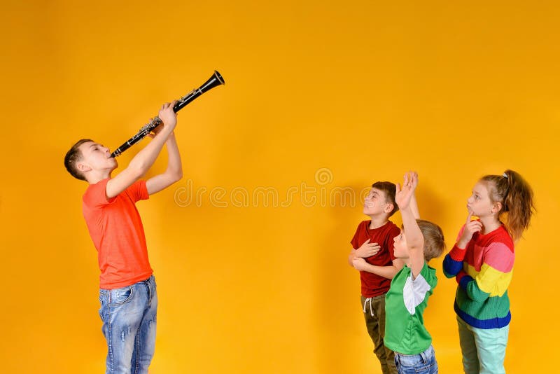 The Boy Plays the Clarinet, and the Children Listen with Admiration ...