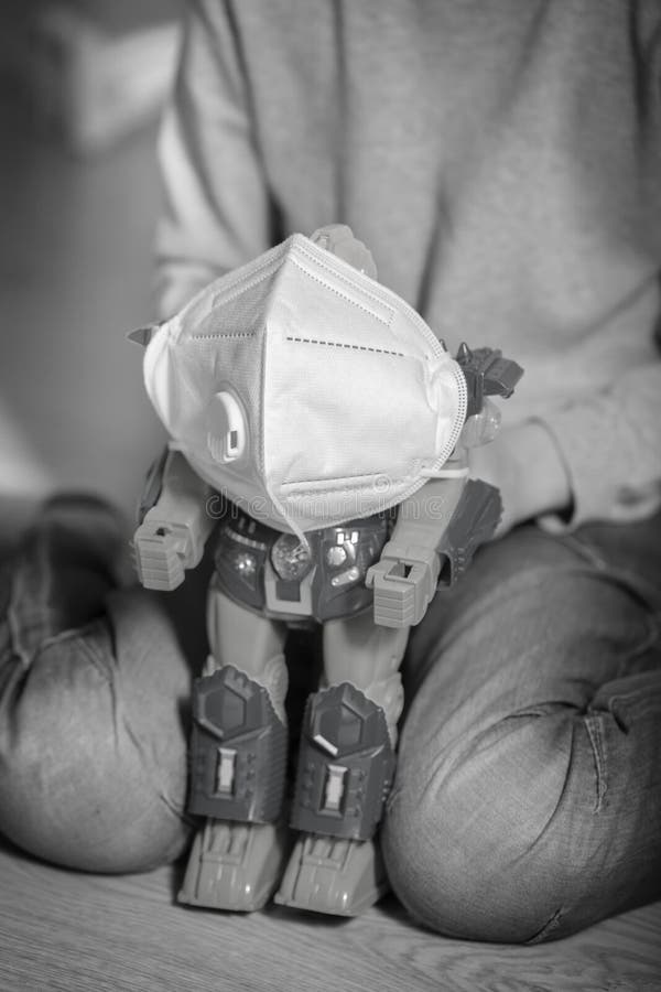 Boy Plays with Coronavirus Protection Mask and Robot Stock Image ...