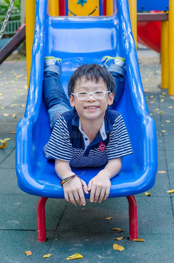 Boy plays at playground stock photo. Image of playground - 66389114