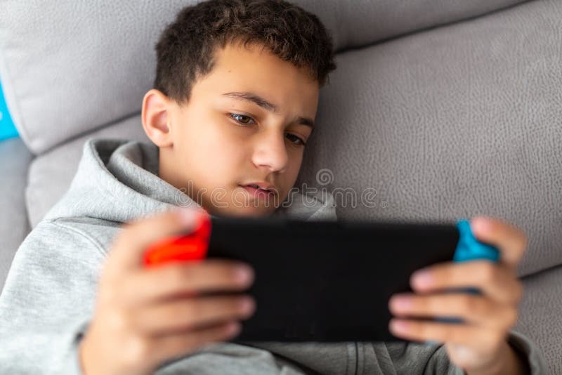 Boy Plays Video Games on a Portable Console Stock Photo - Image of ...