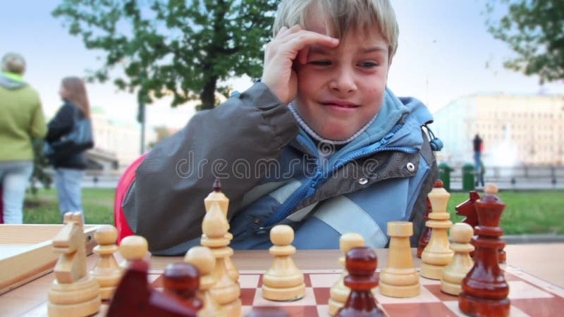 Boy Plays Wooden Chess in Park, People Walk Stock Footage - Video of ...