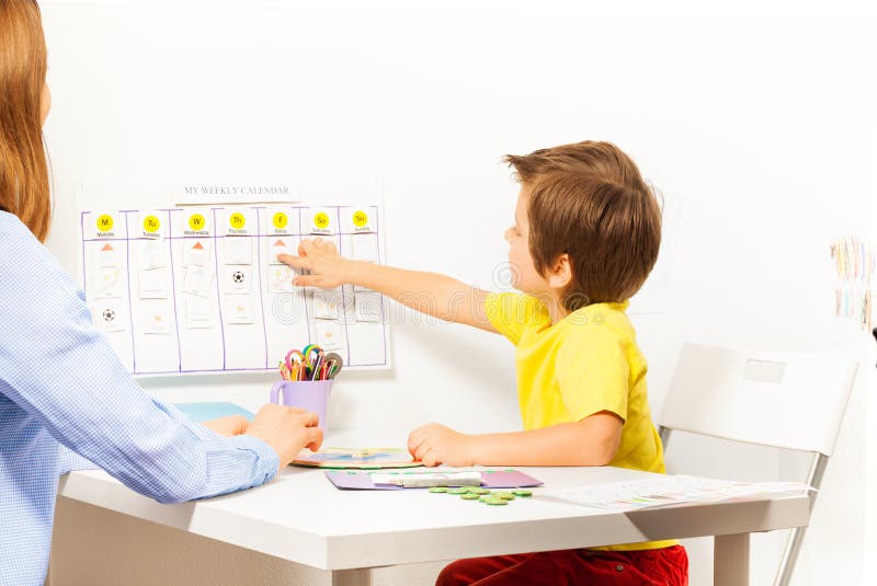 Boy Points at Activities on Calendar Learning Days Stock Photo - Image ...