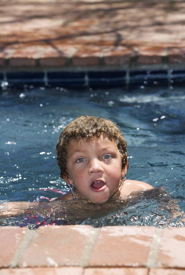 Boy Splashing in a Pool stock image. Image of swmming - 9184701